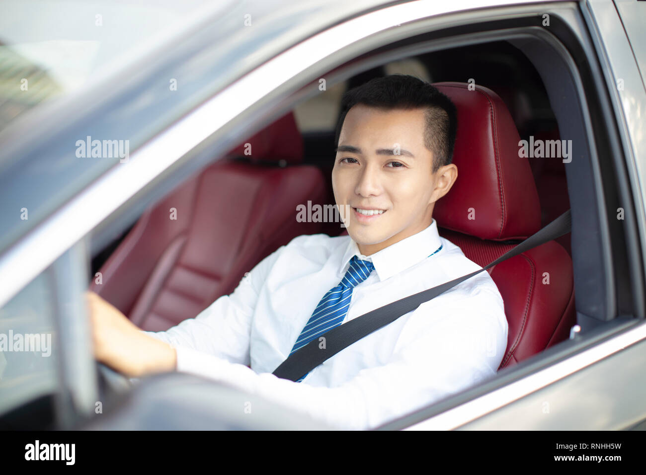 Young chinese man driving car hi-res stock photography and images - Alamy