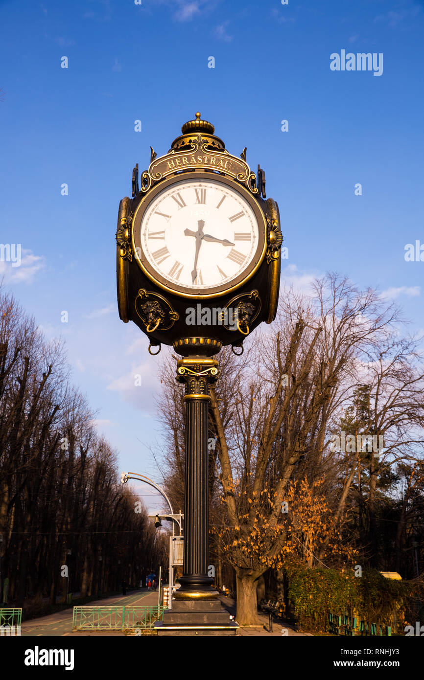 A large clock lined with gold in Herastrau Park, Bucharest Stock Photo ...