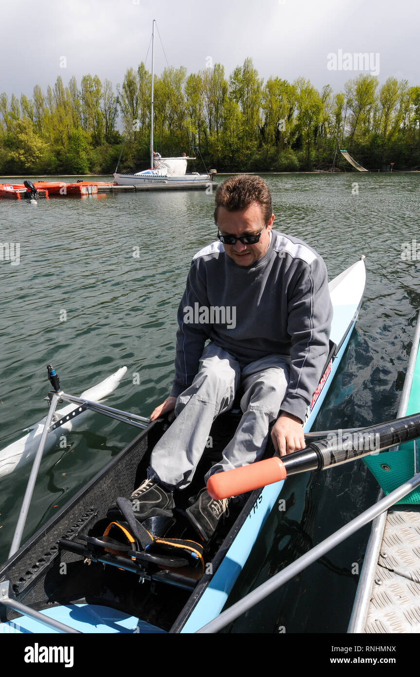Paraplegic man enjoys rowing at Miribel-Jonage Park, France Stock Photo ...
