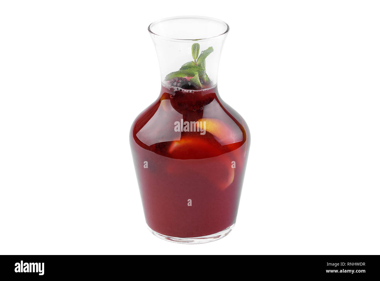 Cocktail in a glass carafe with blackberries and lime and sweet syrup ...