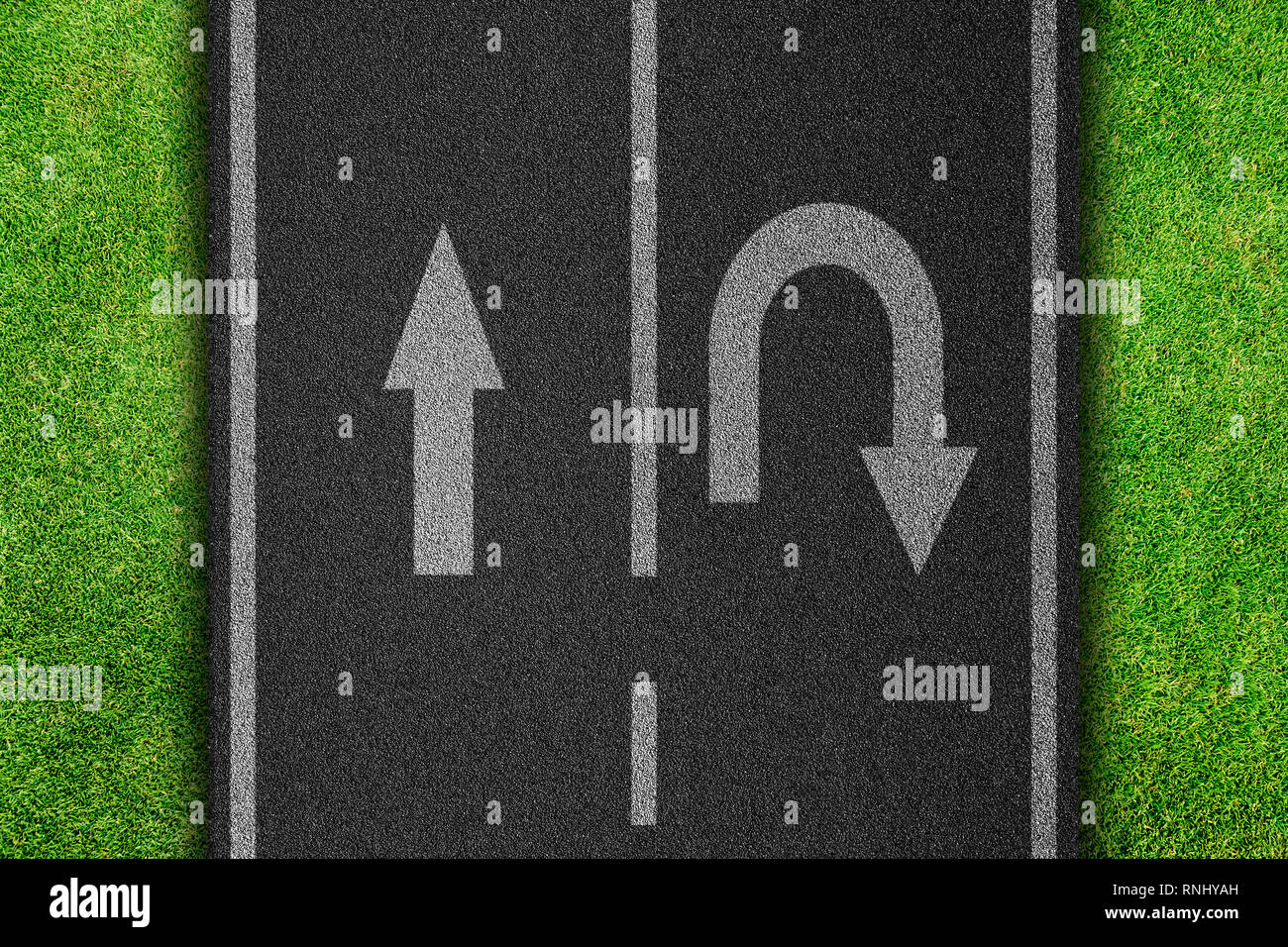 go straight and turn back asphalt road texture background in the grass ...