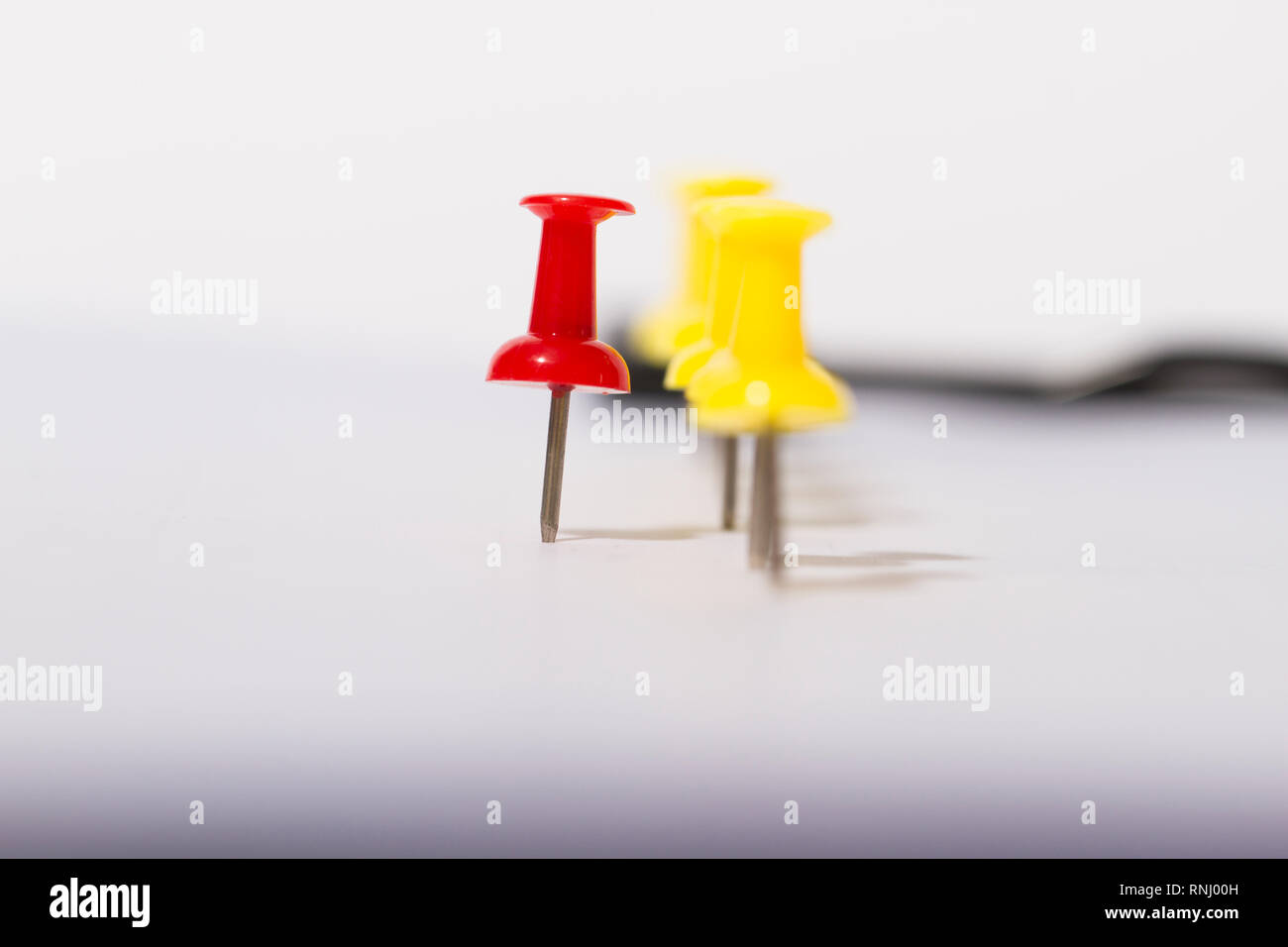 Different red pushpins, highlighted Stock Photo - Alamy