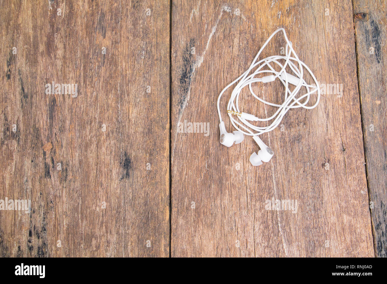 white earphone on table old wooden vintage background and copy space ...