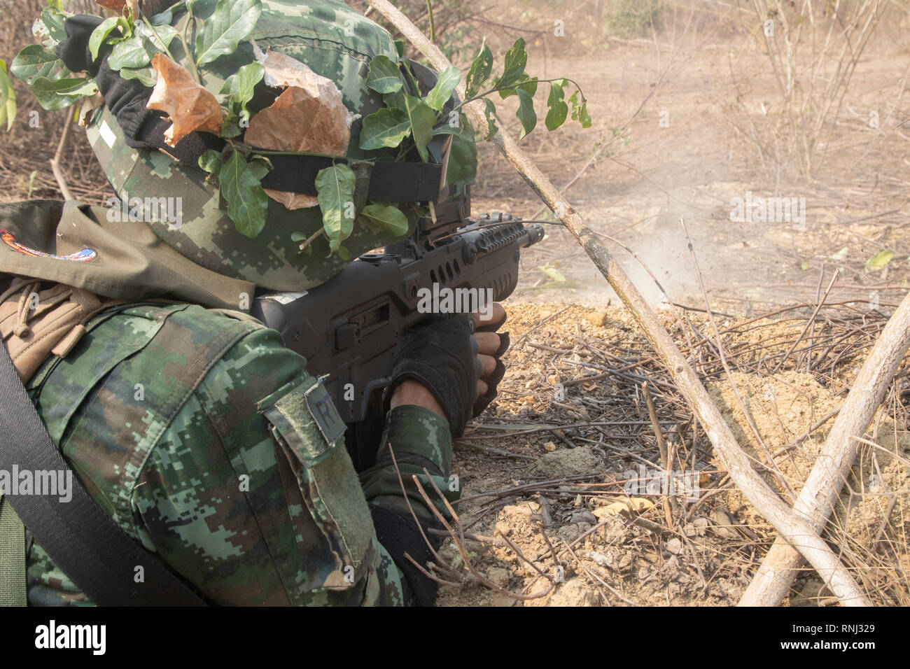 A Royal Thai Army soldier fires his weapon at an enemy target during a ...