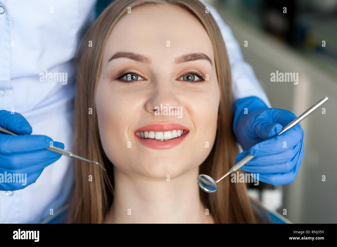 Dentist examining a patient's teeth in the dental clinic Stock Photo ...