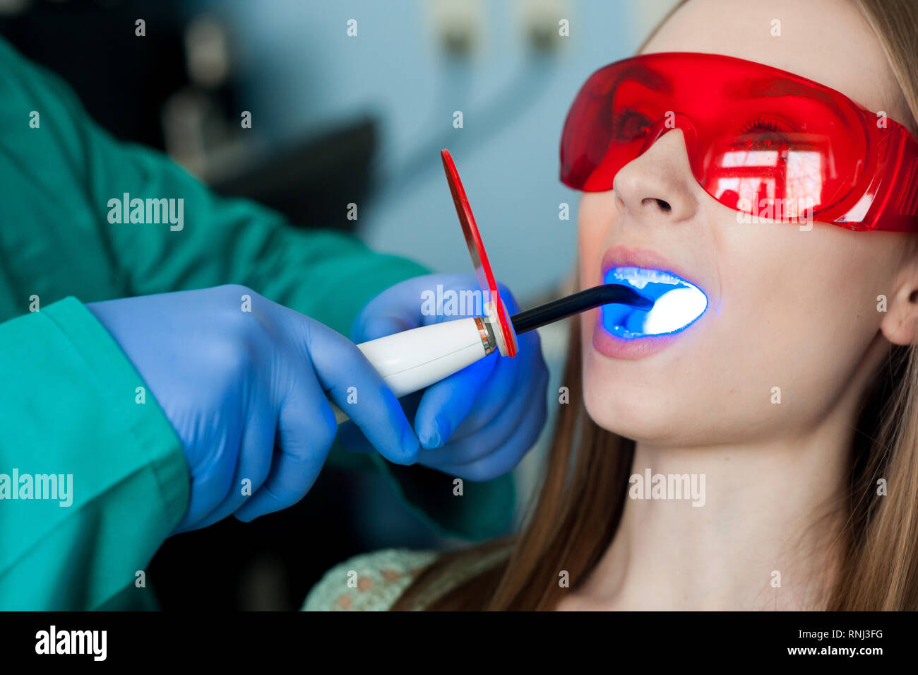 Dentist examining a patient's teeth in the dental clinic Stock Photo ...