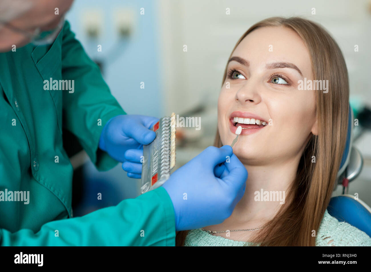Dentist examining a patient's teeth in the dental clinic Stock Photo ...