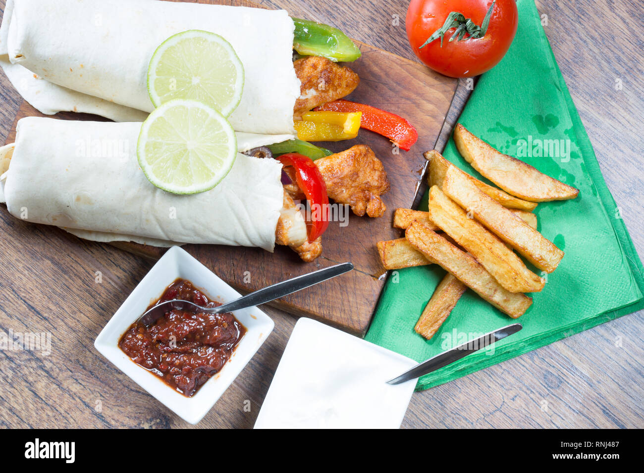 Cooked Chicken fajita served with potato fries and tomato chili dip ...