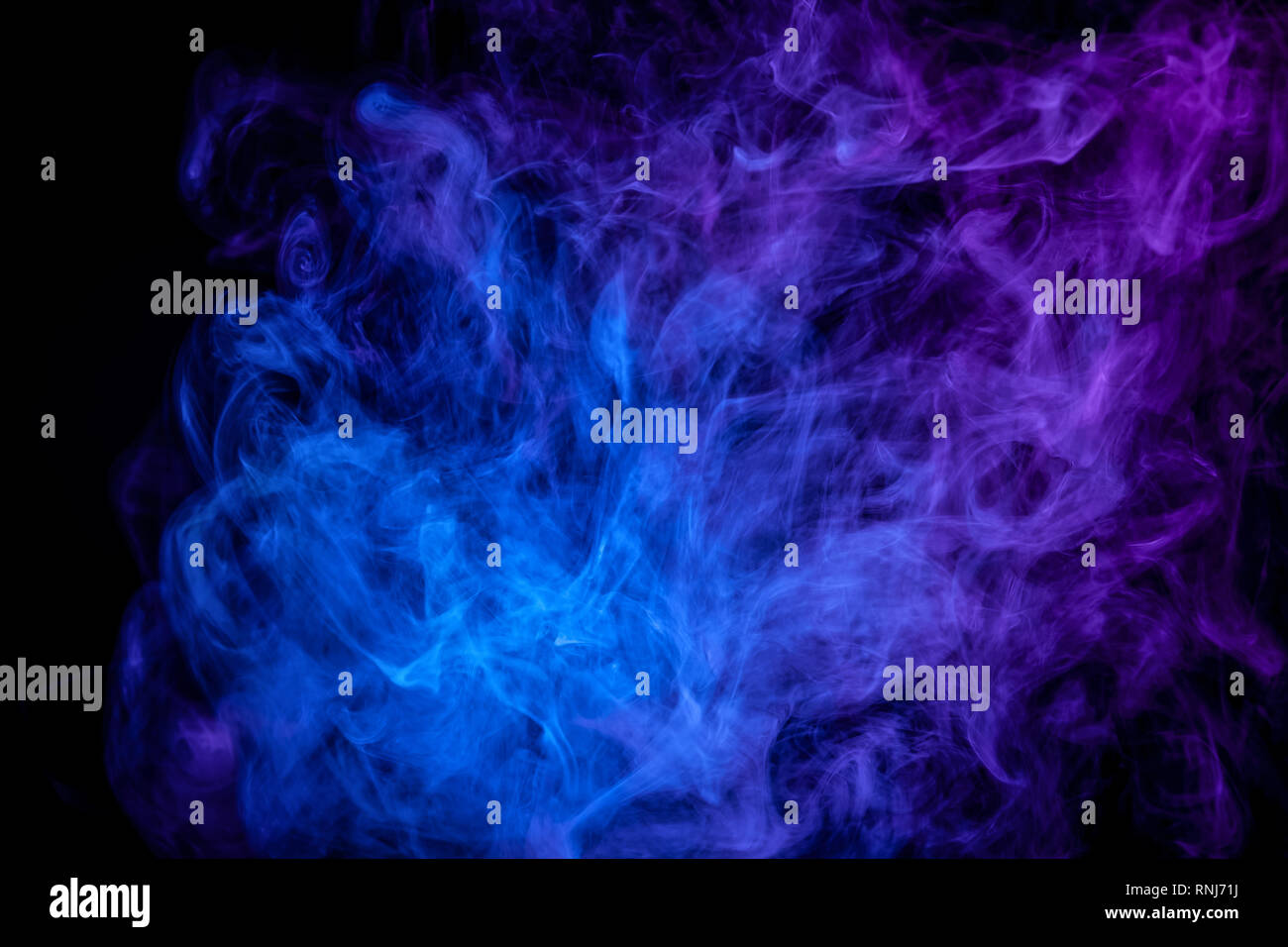Thick colorful blue smoke on a black isolated background. Background ...