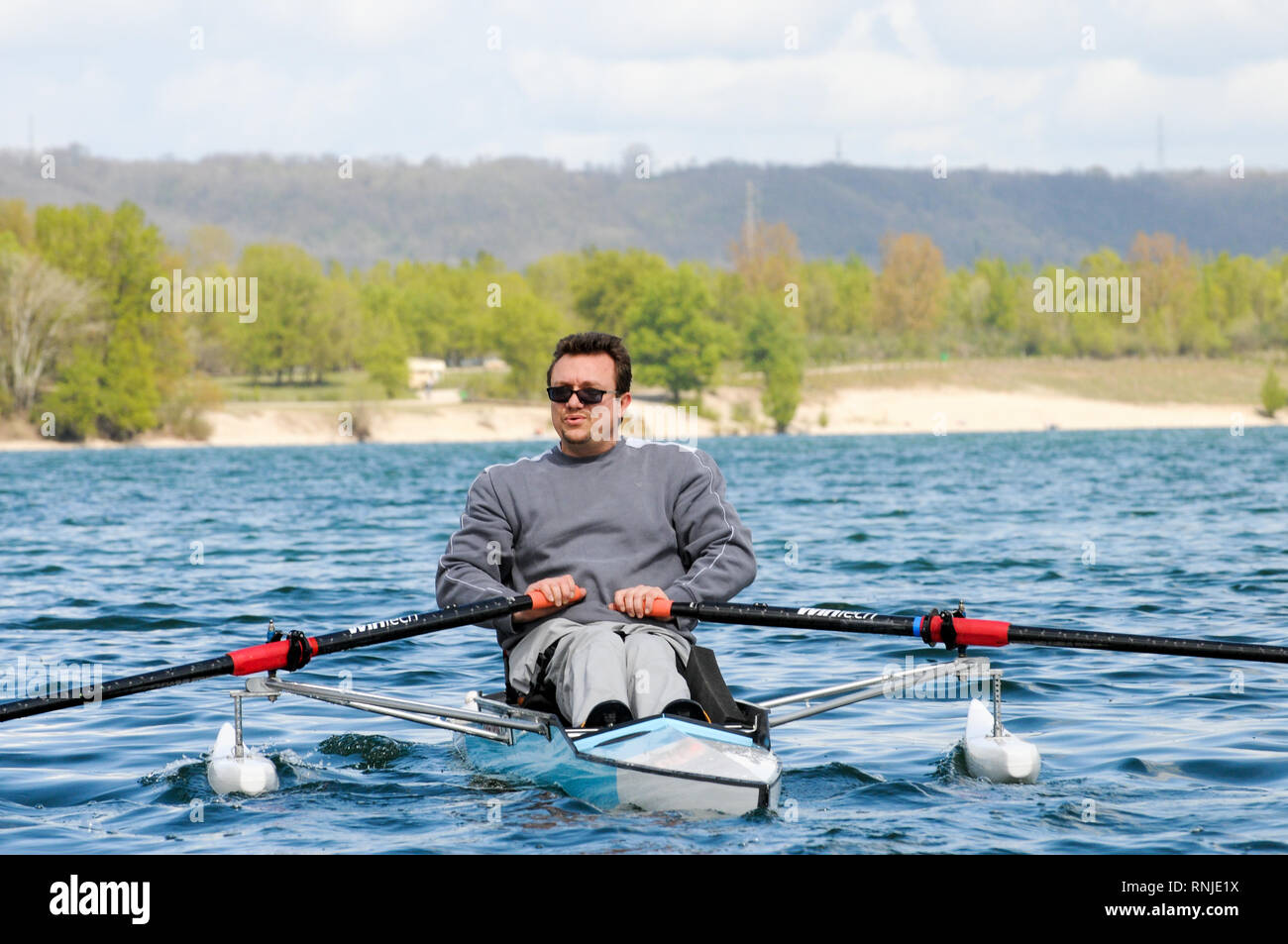 Paraplegic man enjoys rowing at Miribel-Jonage Park, France Stock Photo ...