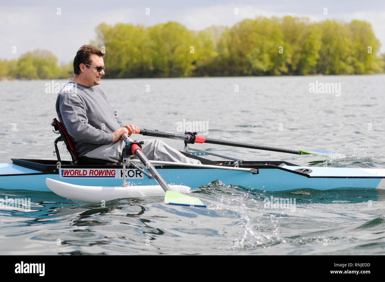 Paraplegic man enjoys rowing at Miribel-Jonage Park, France Stock Photo ...