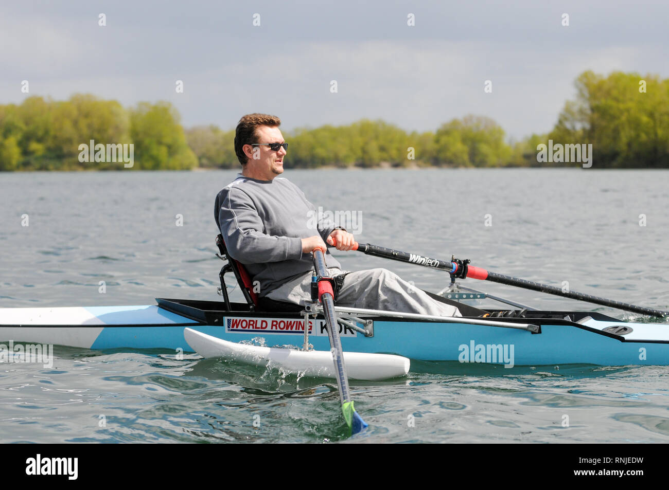 Paraplegic man enjoys rowing at Miribel-Jonage Park, France Stock Photo ...