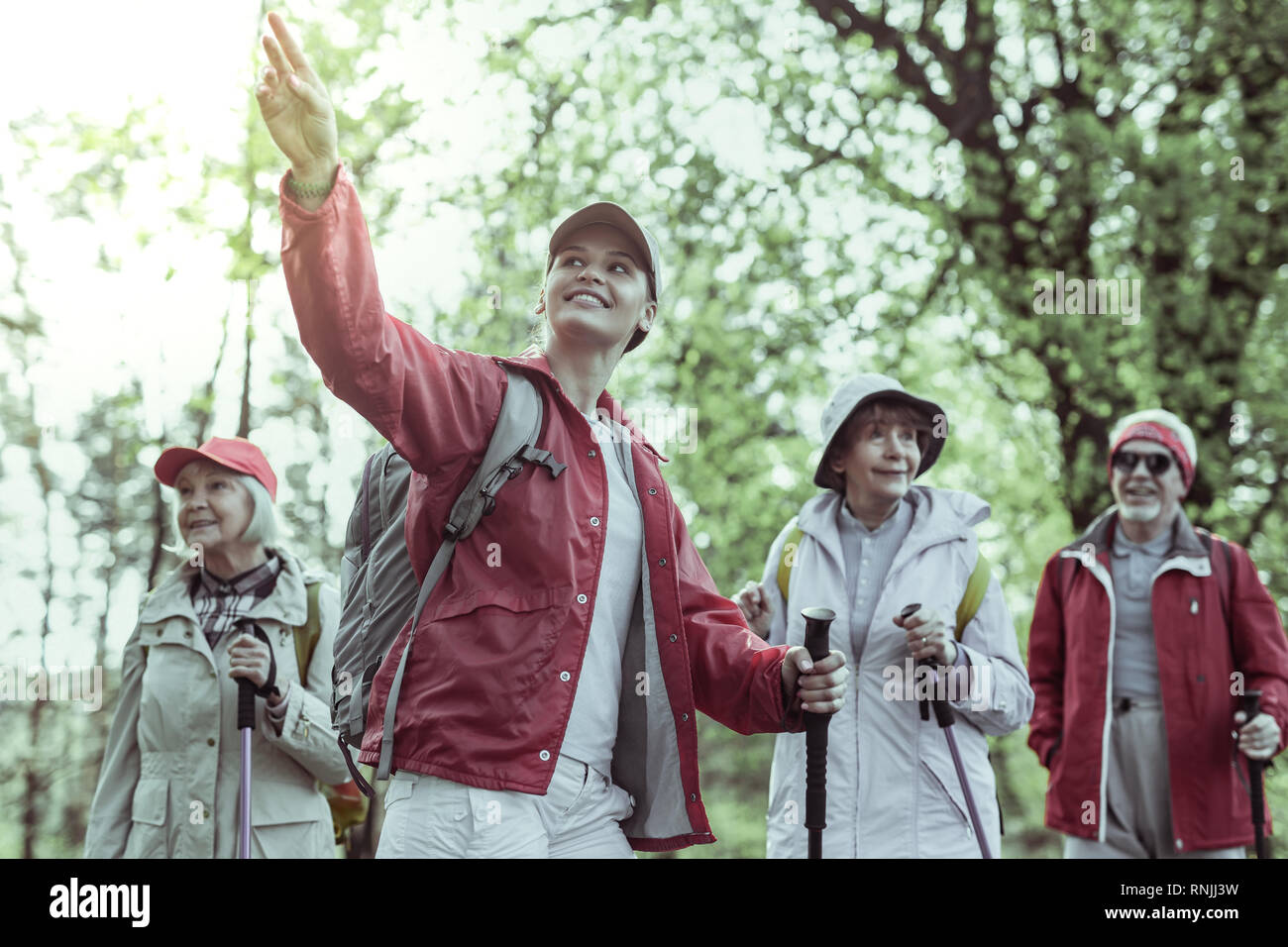 Woman making an excursion for the group of seniors Stock Photo - Alamy