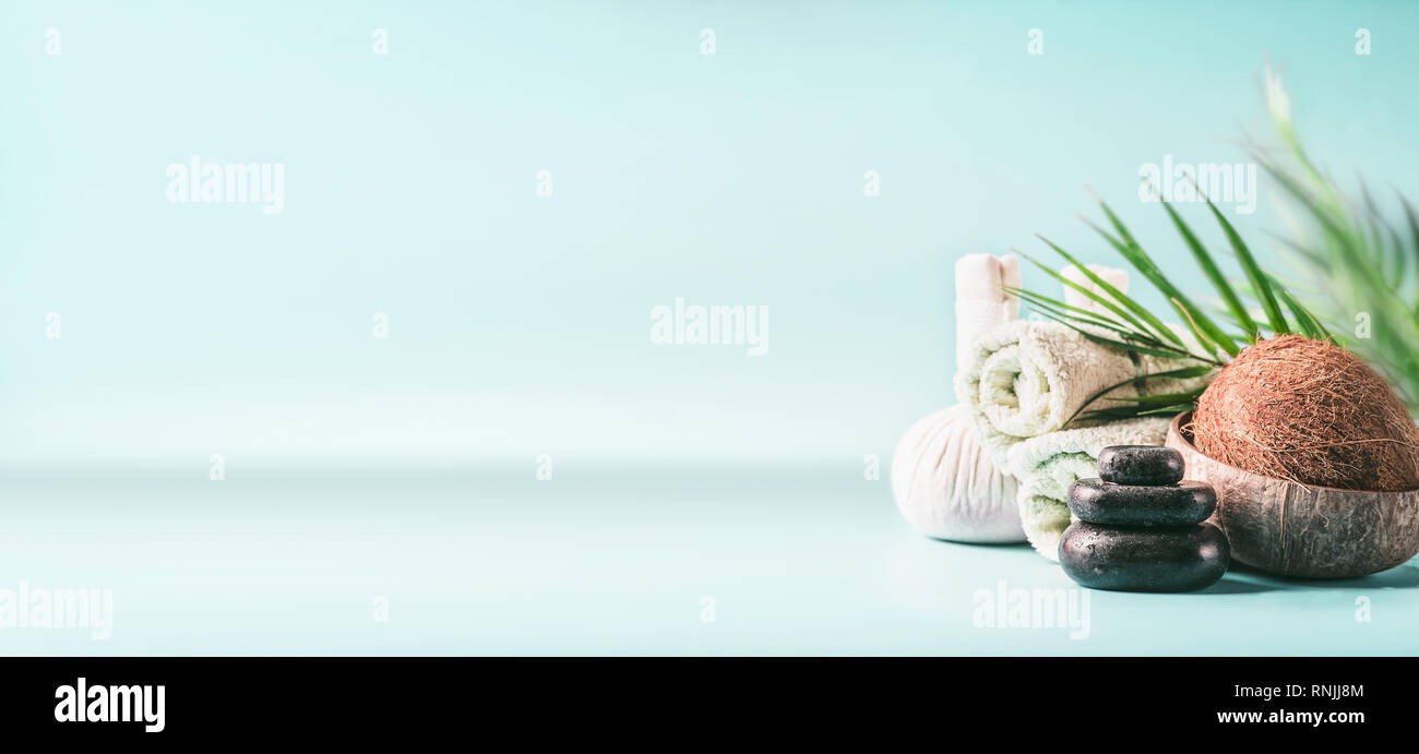 Tropical spa setting background with coconut, palm leaves at light blue ...
