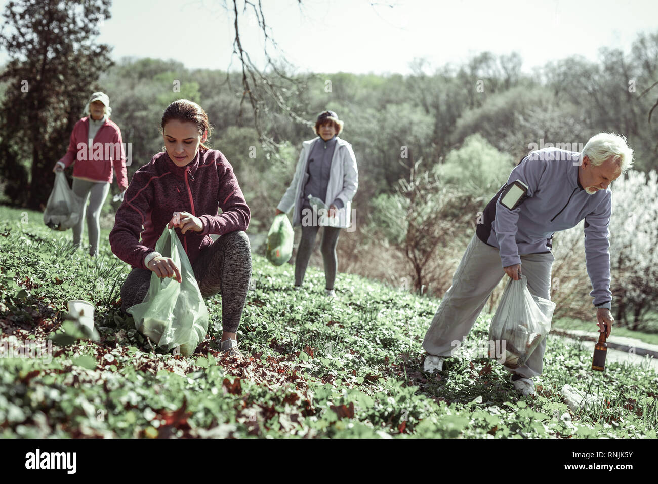 Volunteers cleaning up forest after inferior people Stock Photo - Alamy
