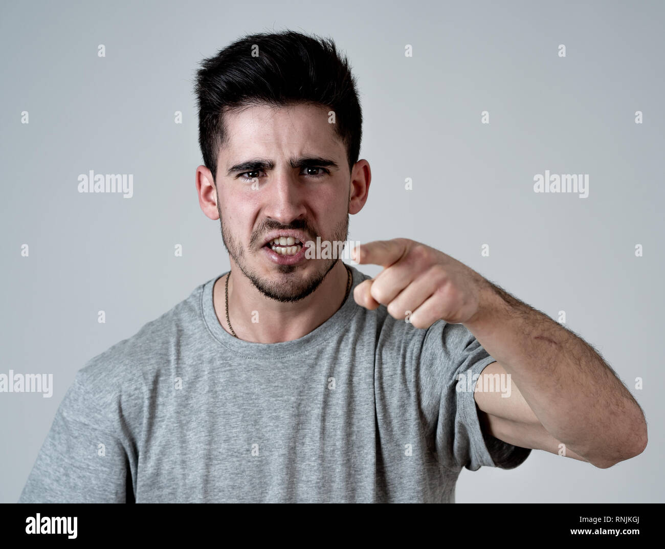 Close up portrait of young violent man with angry face looking furious ...