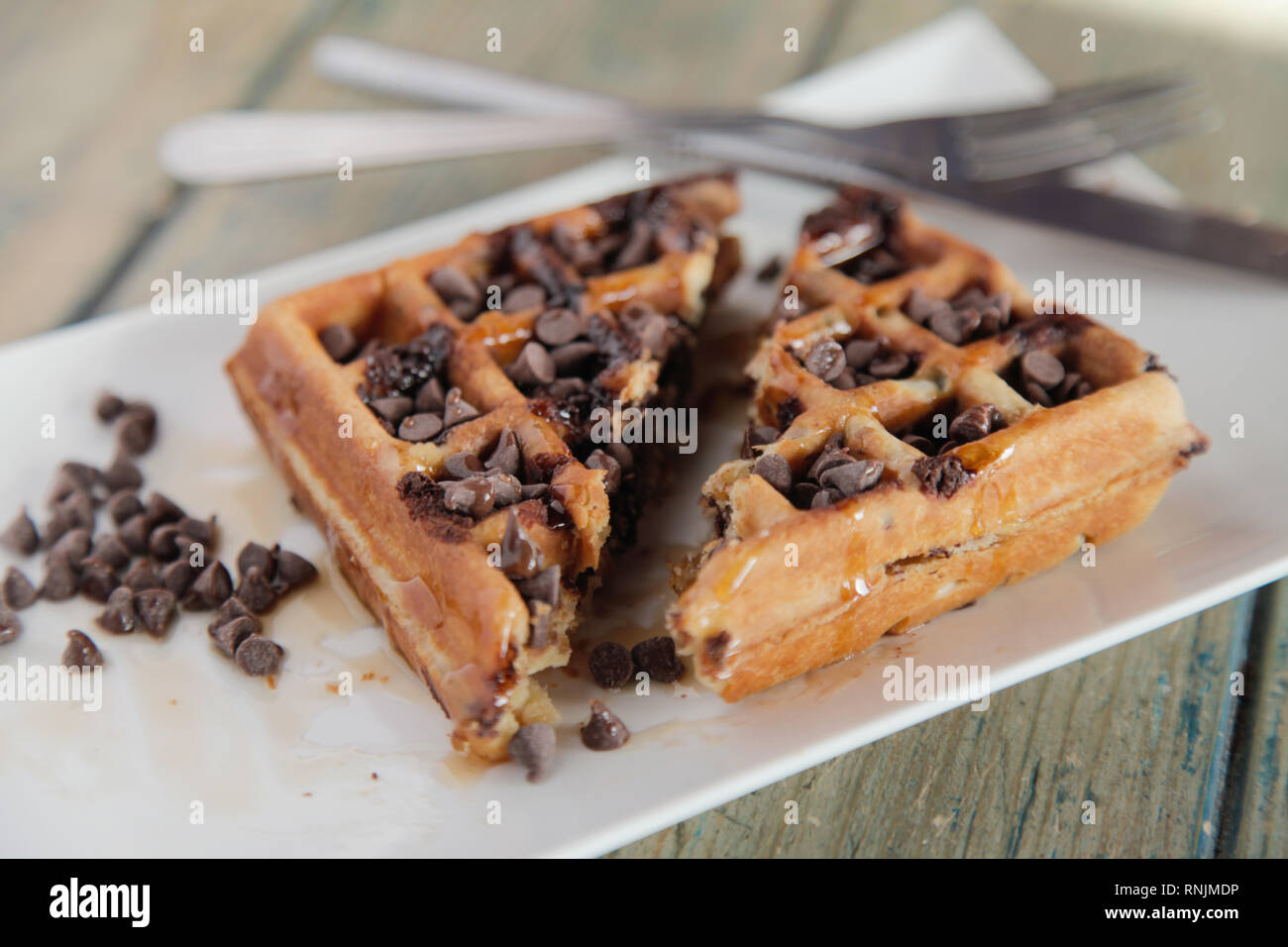Chocolate chip waffle cut into half Stock Photo - Alamy