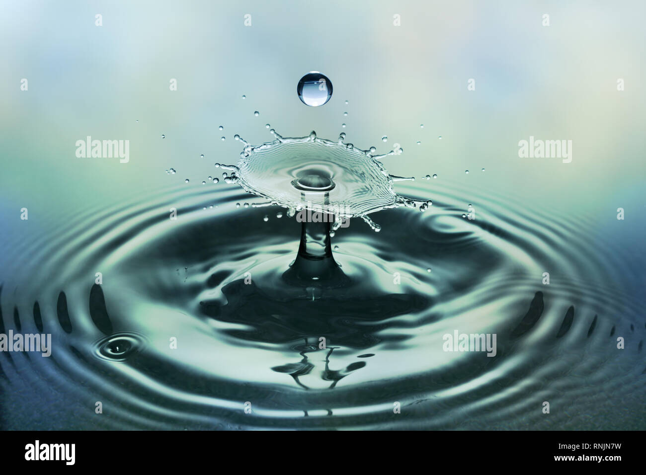 Water splash. Collision effect of two falling rain drops. Green ...