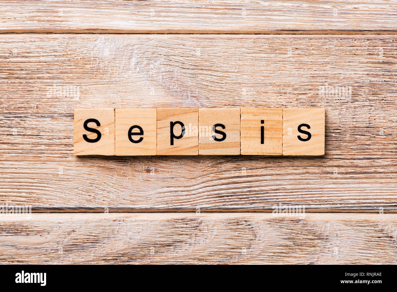 Sepsis word written on wood block. Sepsis text on wooden table for your ...