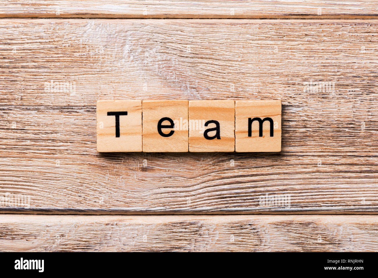 team word written on wood block. team text on wooden table for your ...