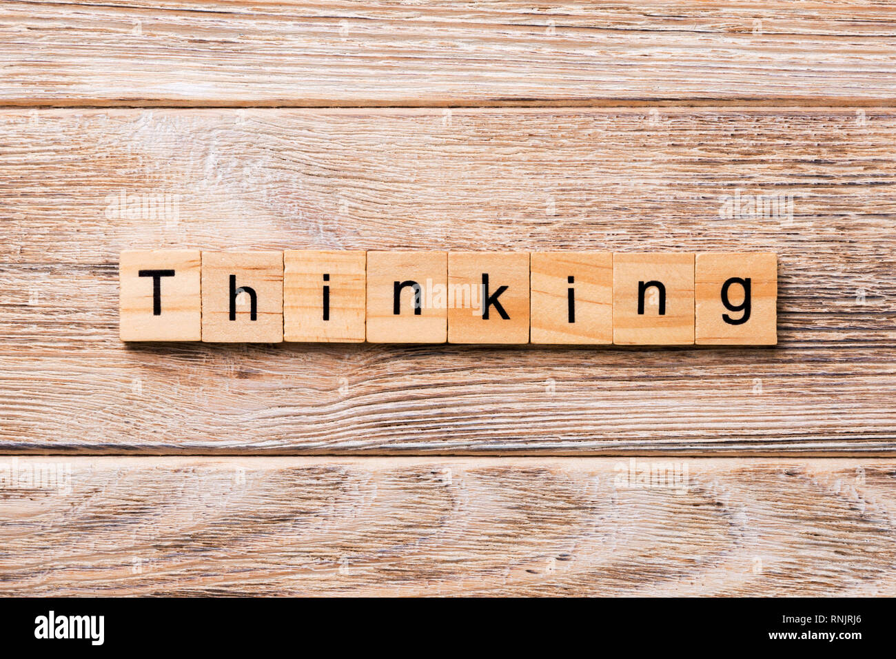 thinking word written on wood block. thinking text on wooden table for ...