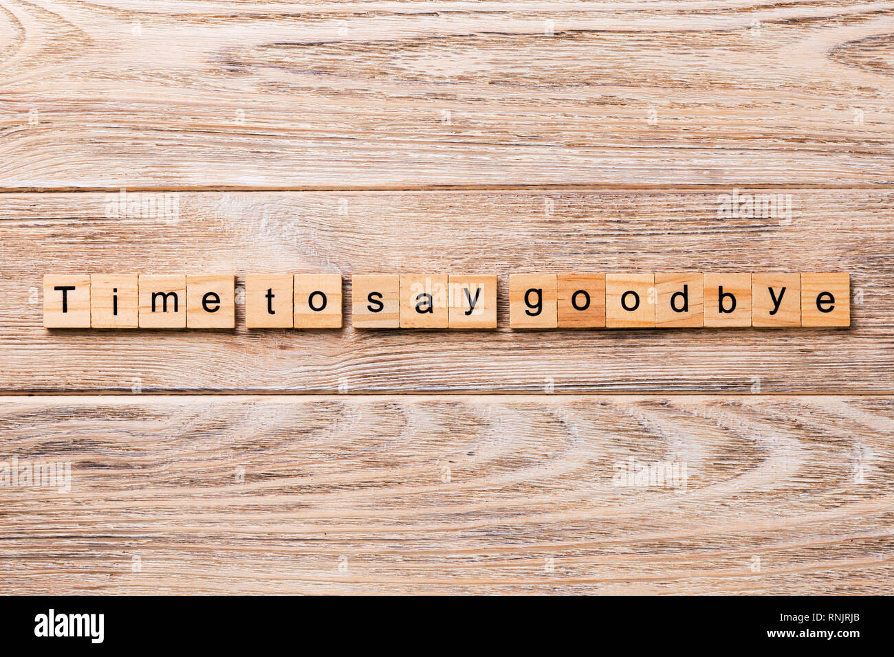 Time to say goodbye word written on wood block. Time to say goodbye ...