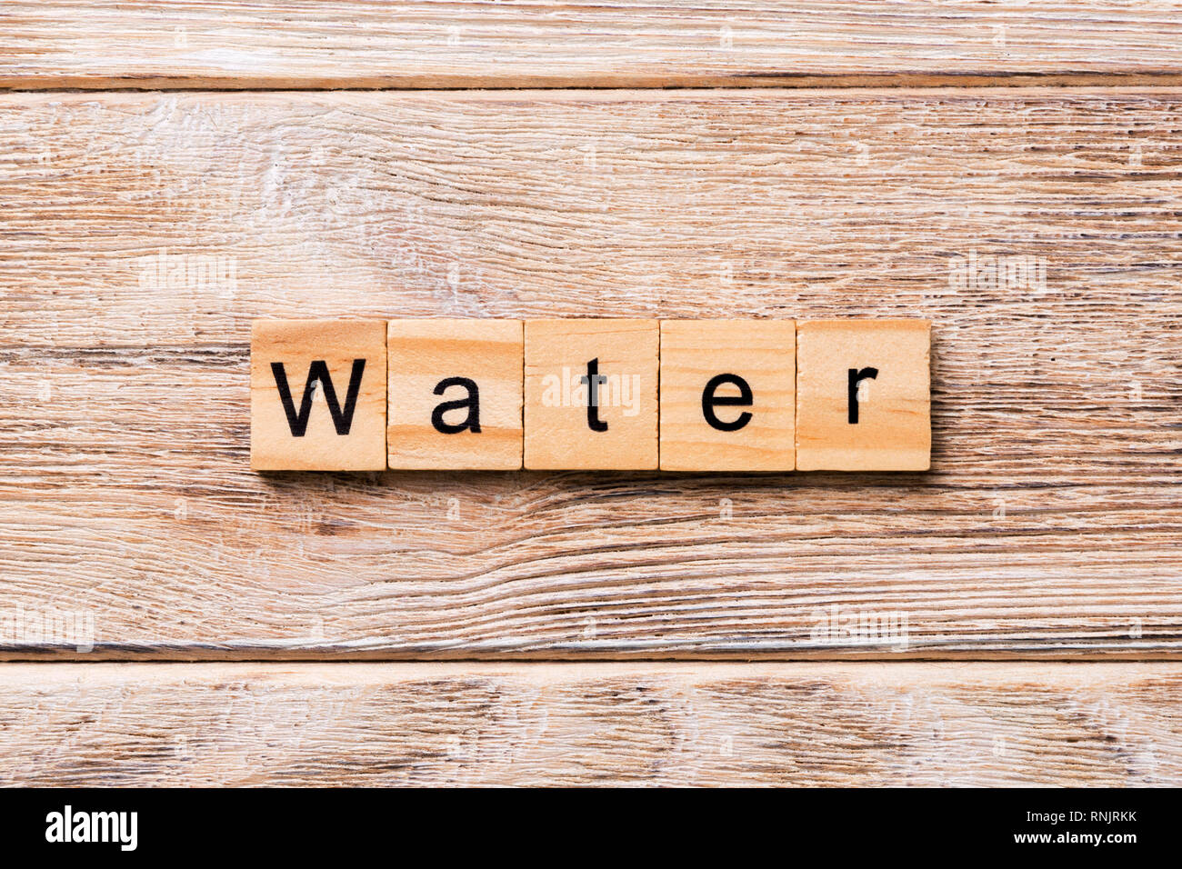 water word written on wood block. water text on wooden table for your ...