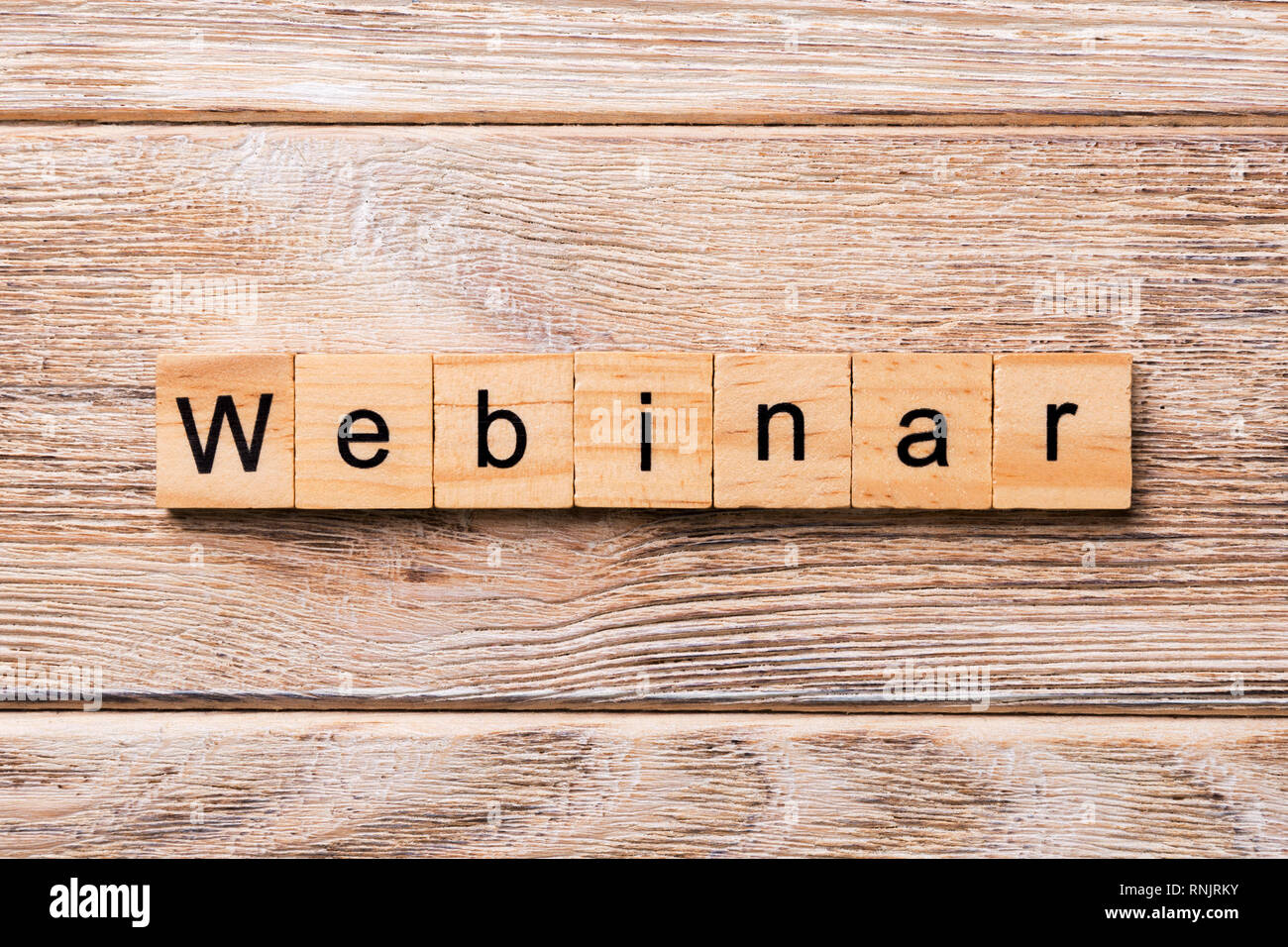 WEBINAR word written on wood block. WEBINAR text on wooden table for ...