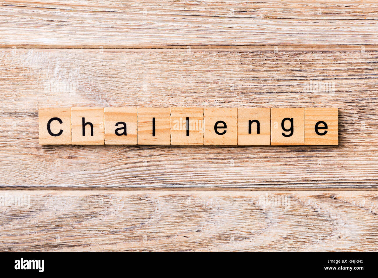 CHALLENGE word written on wood block. CHALLENGE text on wooden table ... CHALLENGE word written on wood block. CHALLENGE text on wooden table ...