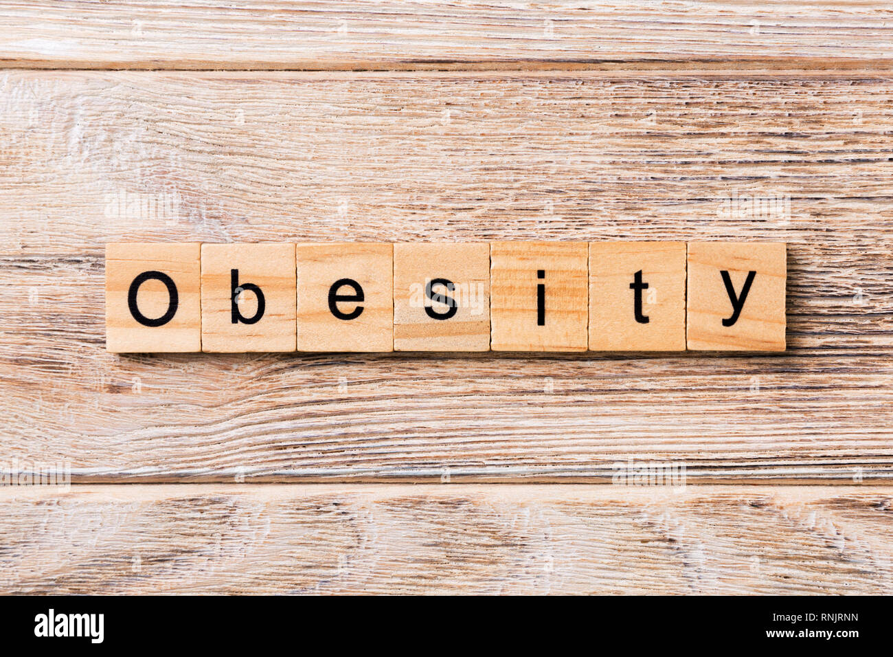 Obesity word written on wood block. Obesity text on wooden table for ...