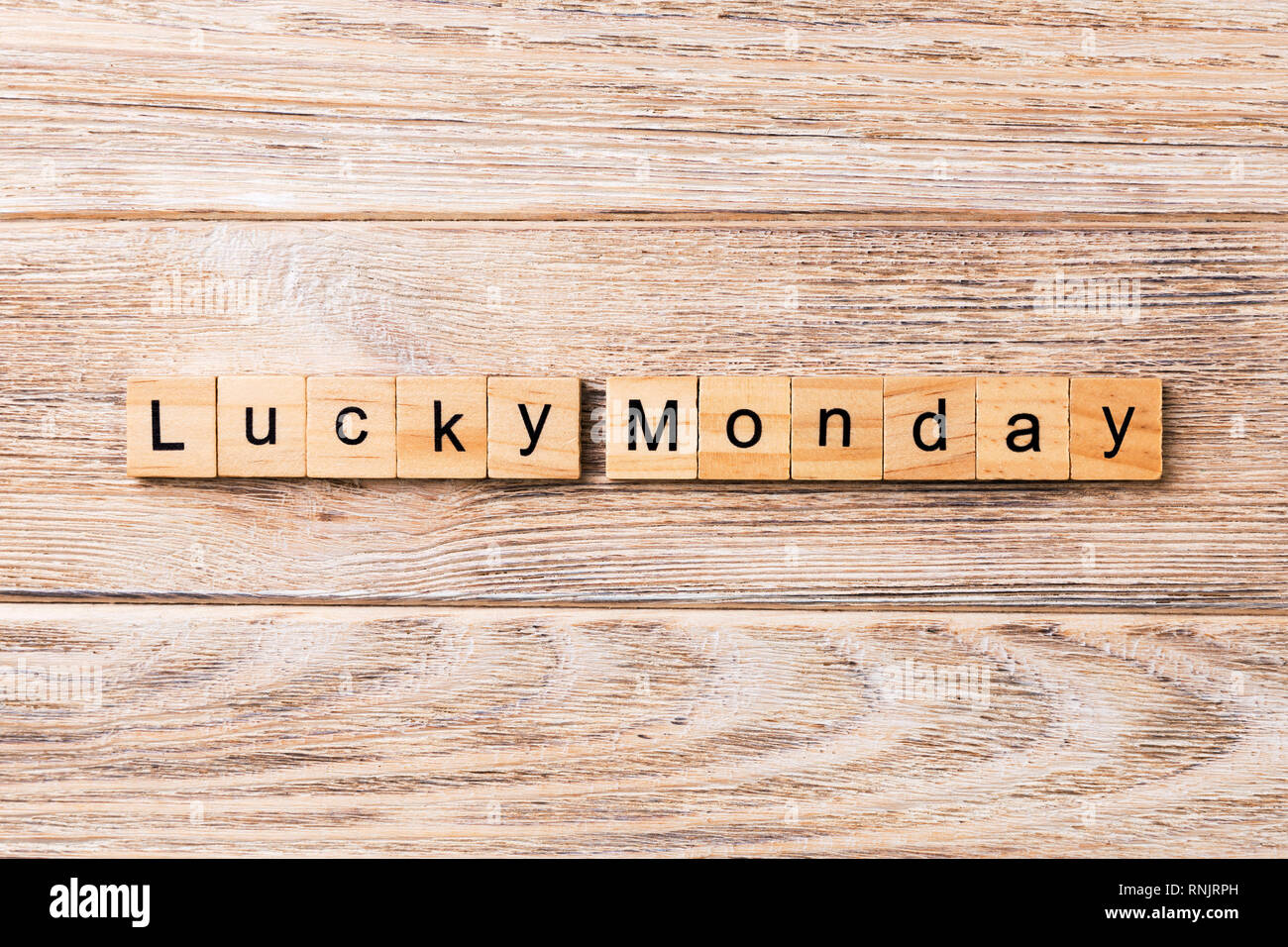 lucky monday word written on wood block. lucky monday text on wooden ...