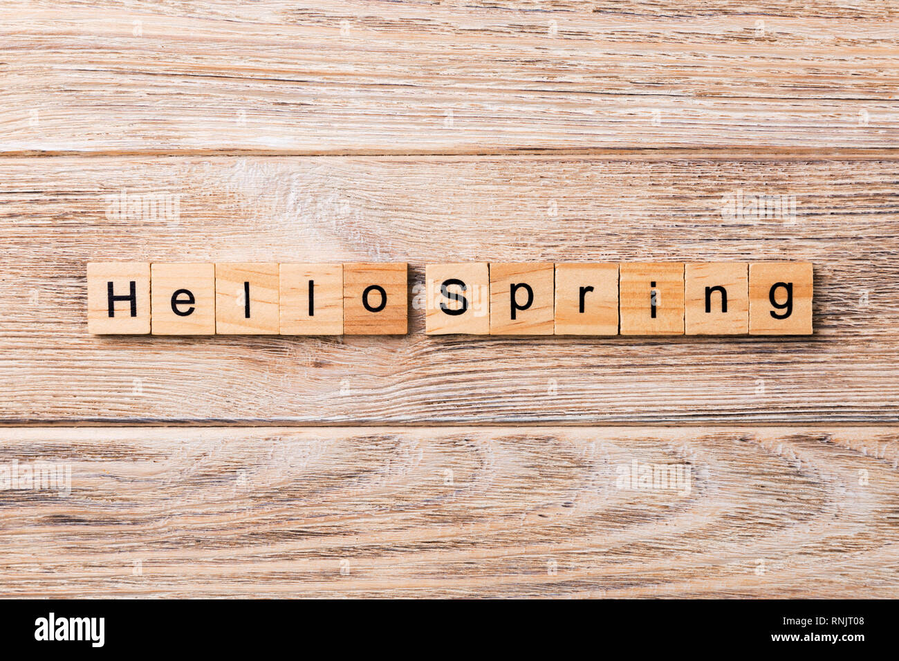 Hello Spring word written on wood block. Hello Spring text on wooden ...