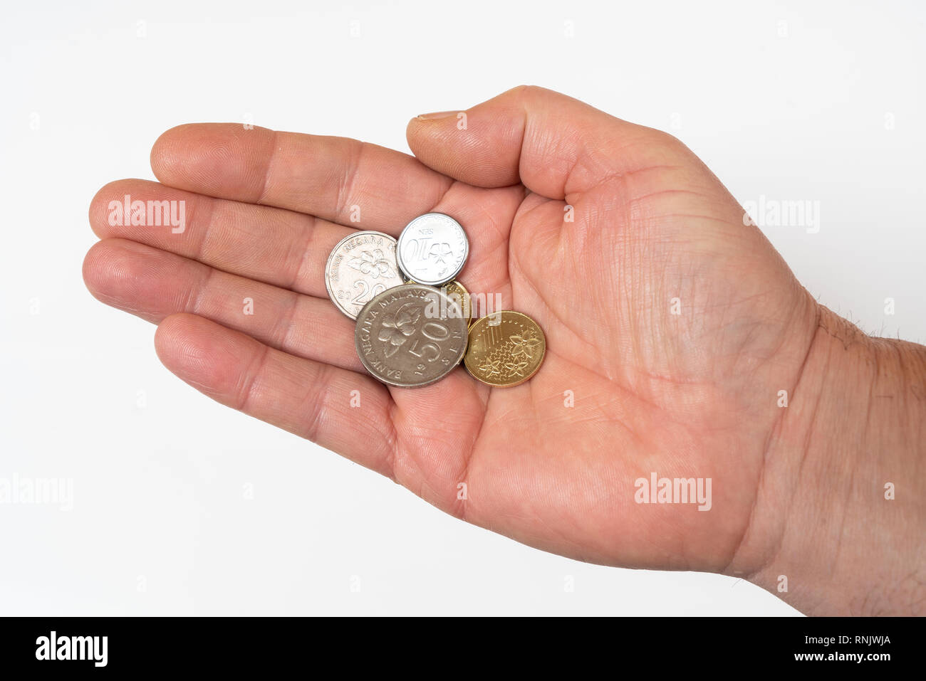 some Malaysian Ringgit coins in the hand Stock Photo - Alamy