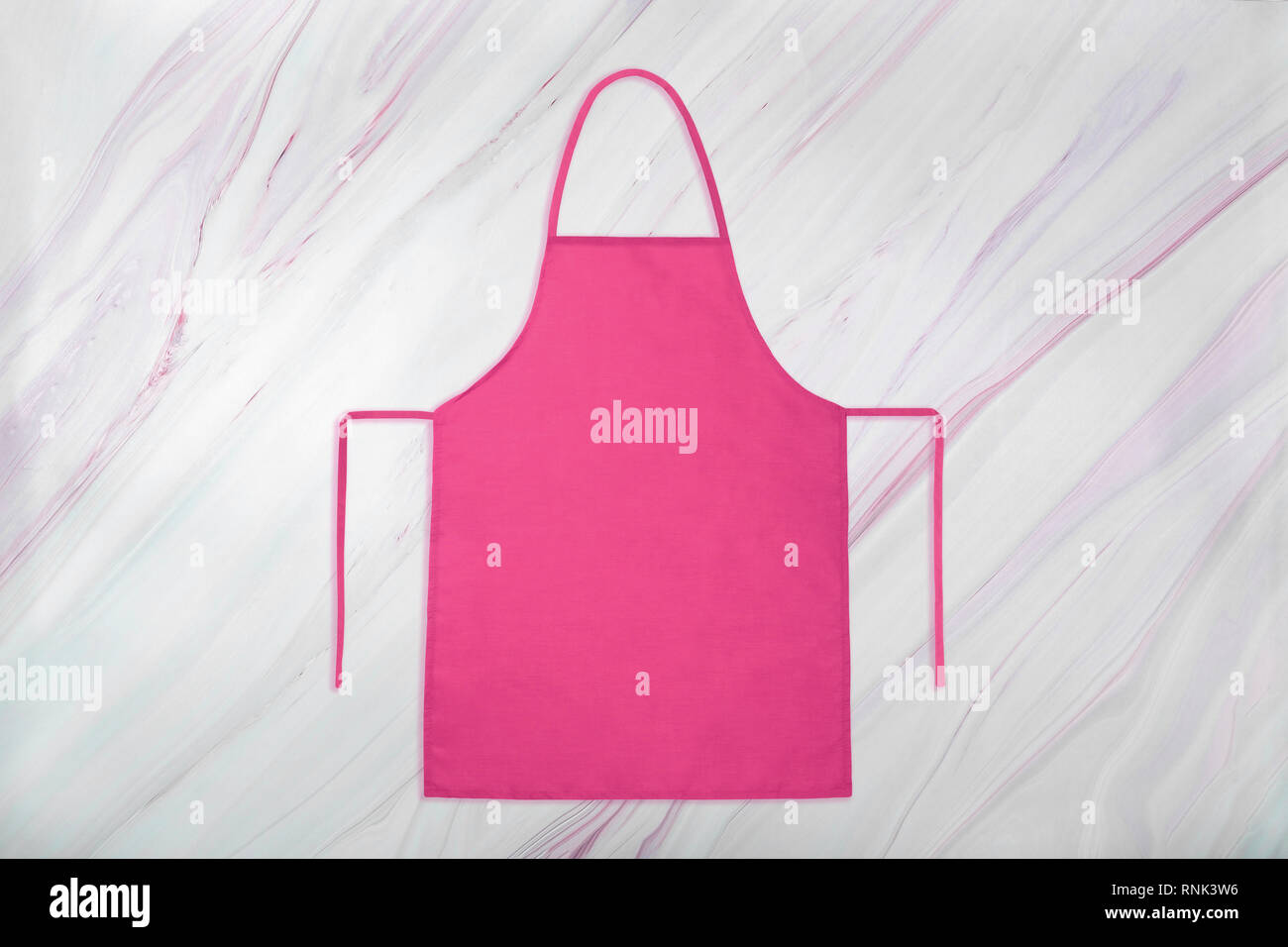 Pink apron on marble background with natural pattern Stock Photo - Alamy