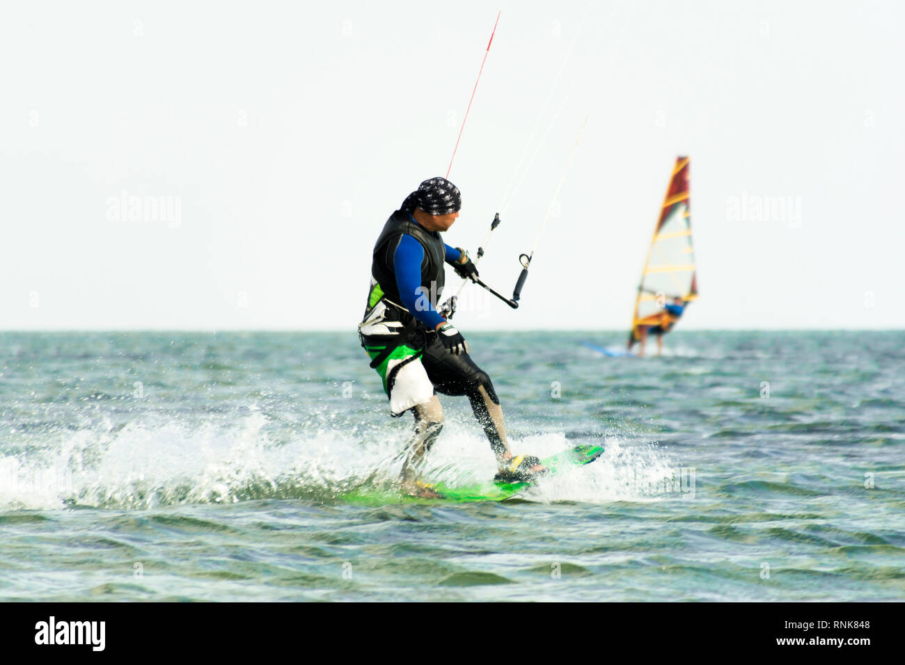 Kitesurfing Kiteboarding action photos man among waves quickly goes ...