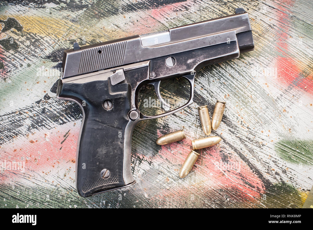 Top view of gun and ammunition on the table. Bullets for pistol in ...