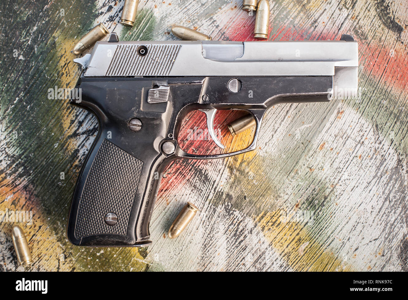 Top view of gun and ammunition on the table. Bullets for pistol in ...