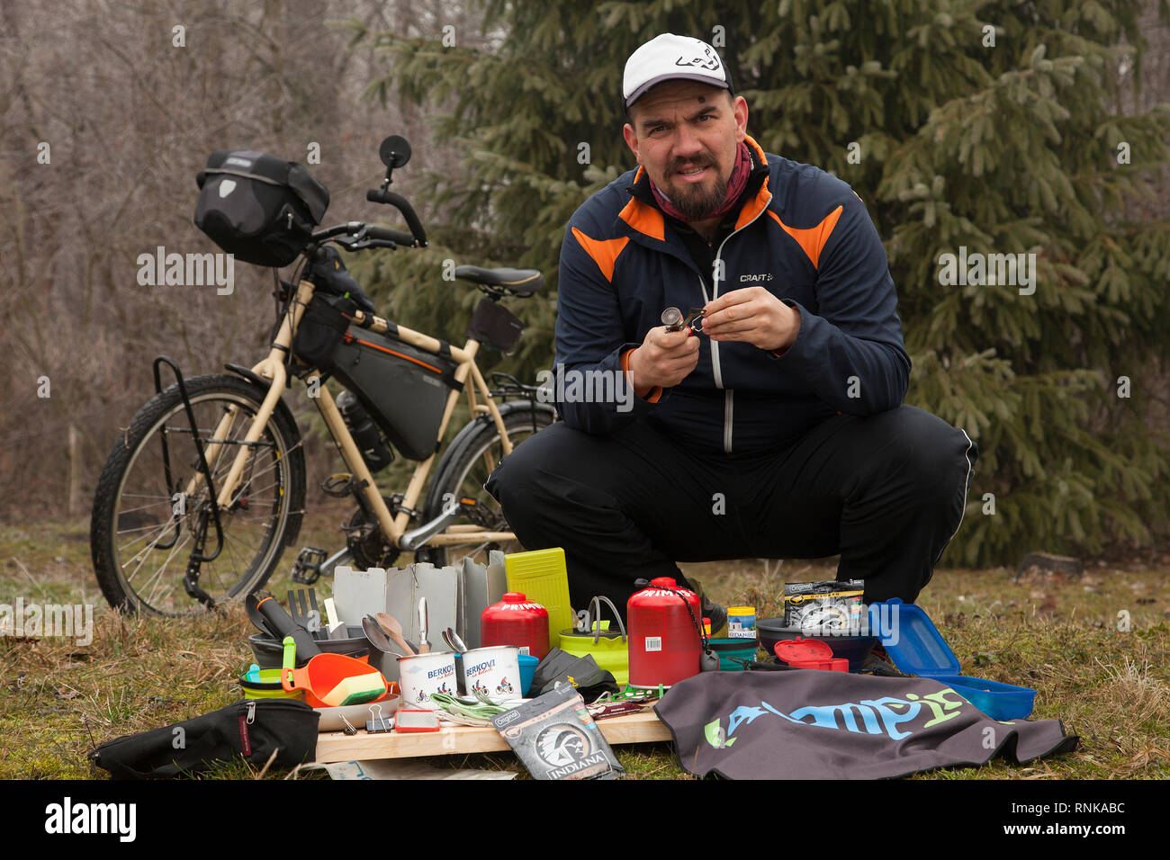 Person packing the bicycle panniers on a long cycle tour with family. A ...