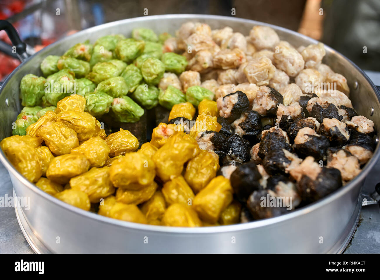 Chrome saucepan with colorful tasty street food on the asian market in ...
