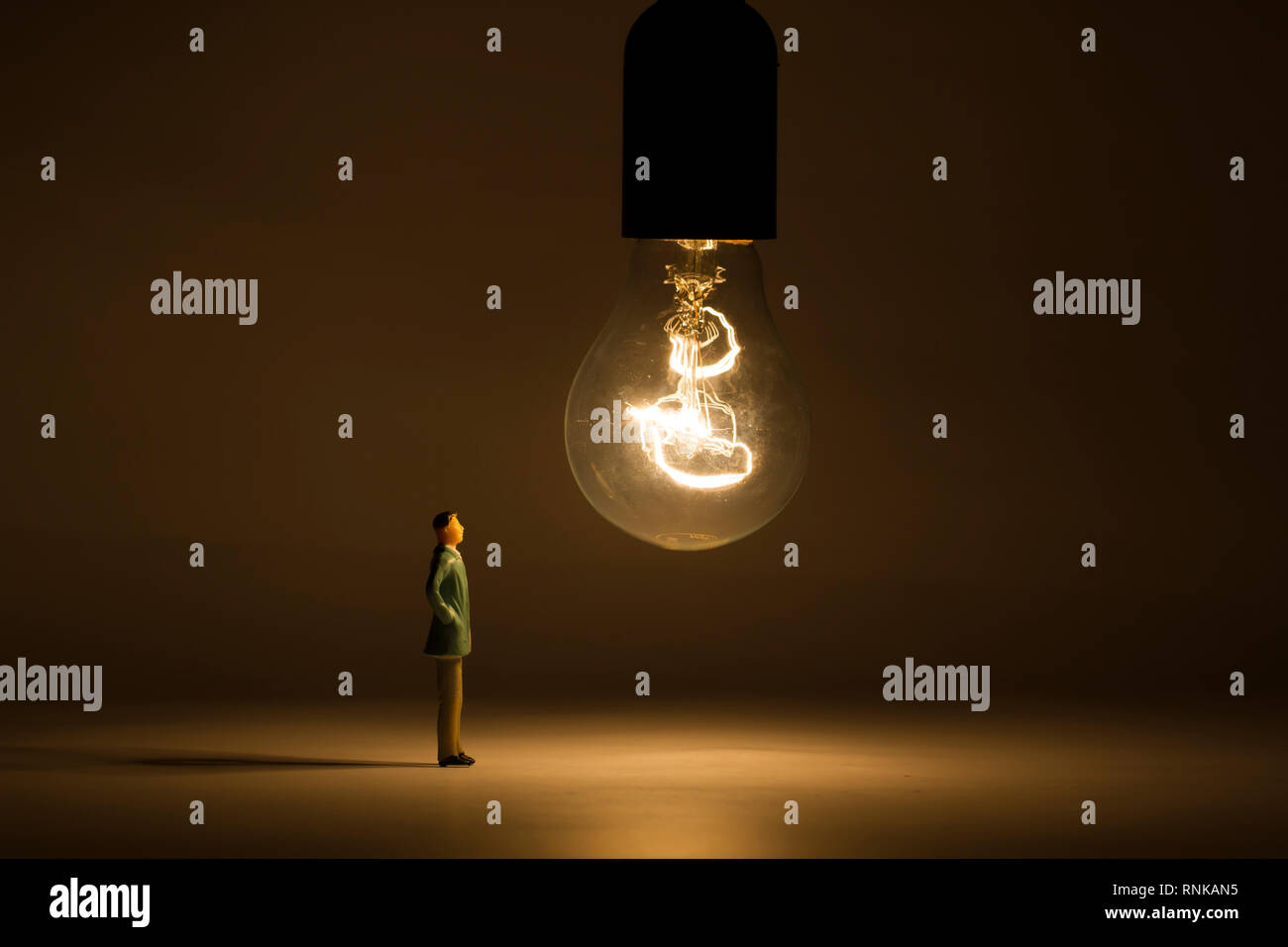Glowing light bulb and villain, guide and guide Stock Photo - Alamy
