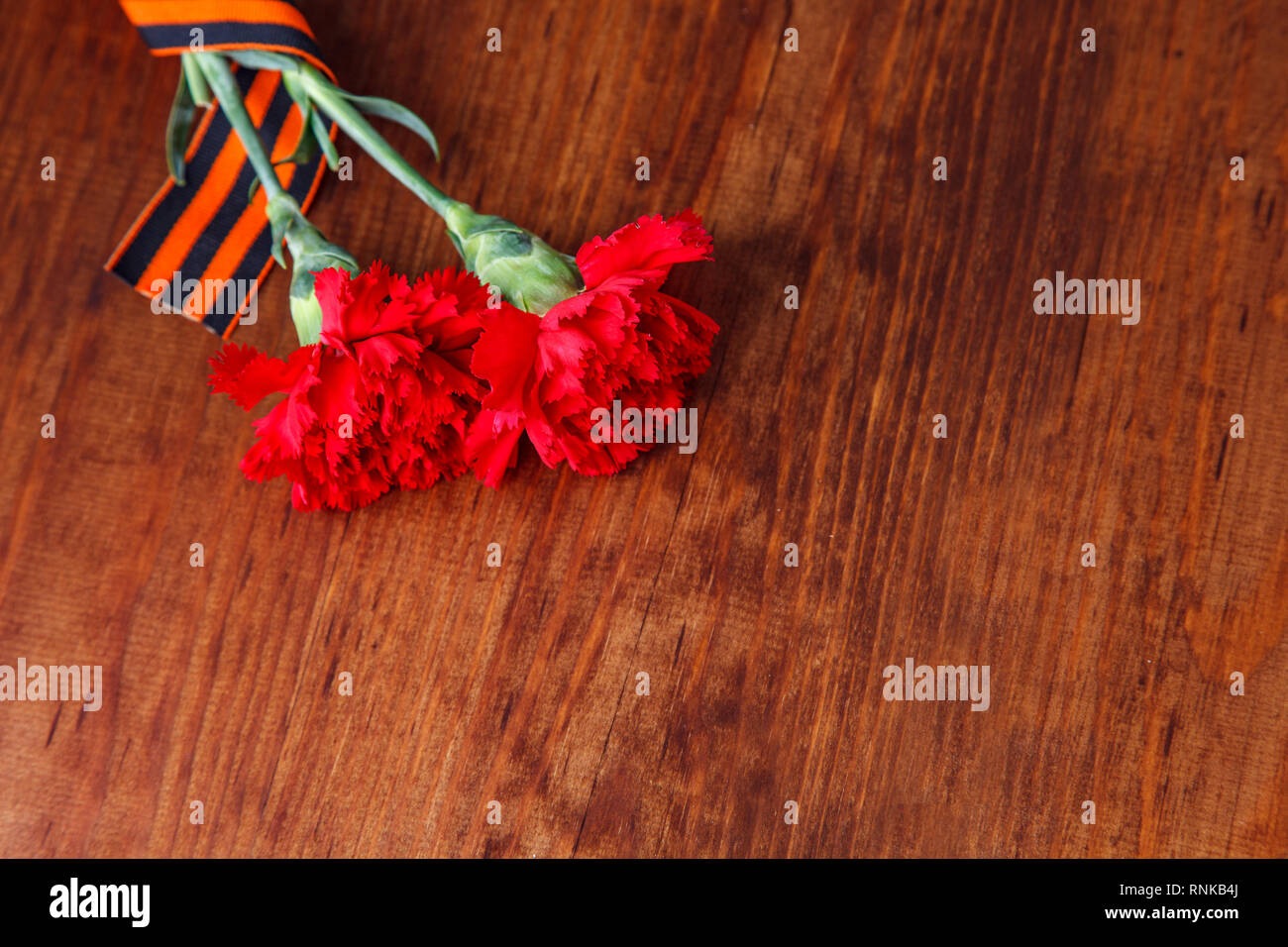 two red flower Symbols of Victory in Great Patriotic War on wooden ...
