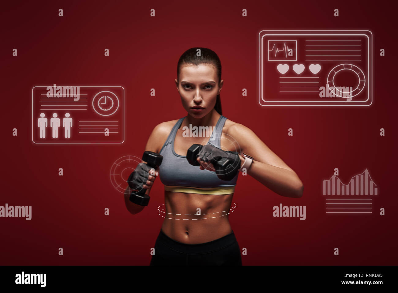 Photo of slim sporty woman doing exercises with small dumbbells over ...