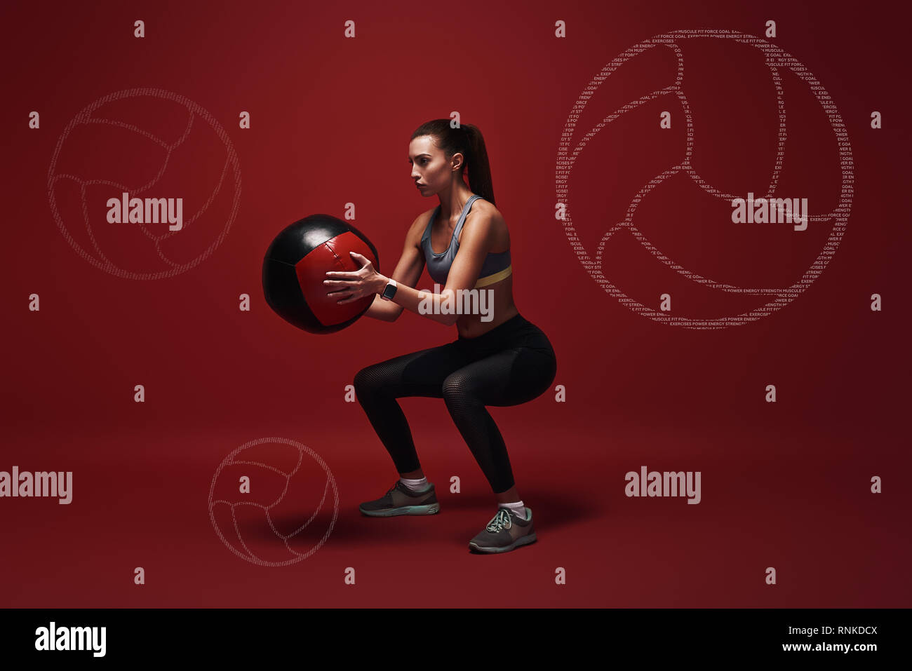 Beautiful sportswoman is doing squats with exercise ball standing over ...