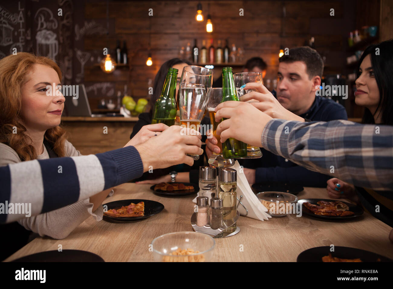 Happy friends restaurant dinner beer hi-res stock photography and ...