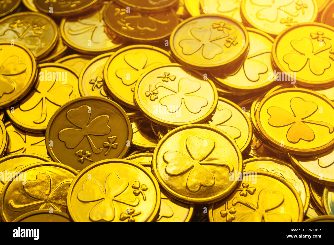 St Patrick's Day background. Golden coins with shamrock under soft ...