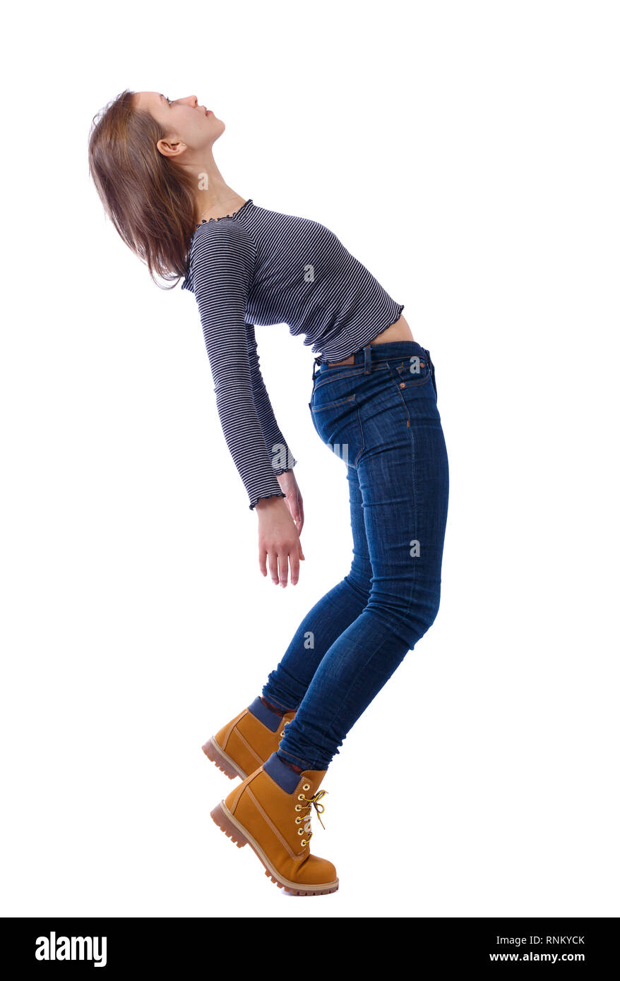 Side view of a woman dancing ballet. The girl is balancing. Rear view ...