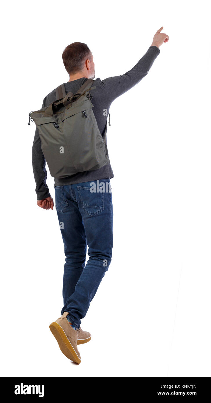 Back view of a walking man with a bag pointing his hand up. backside ...