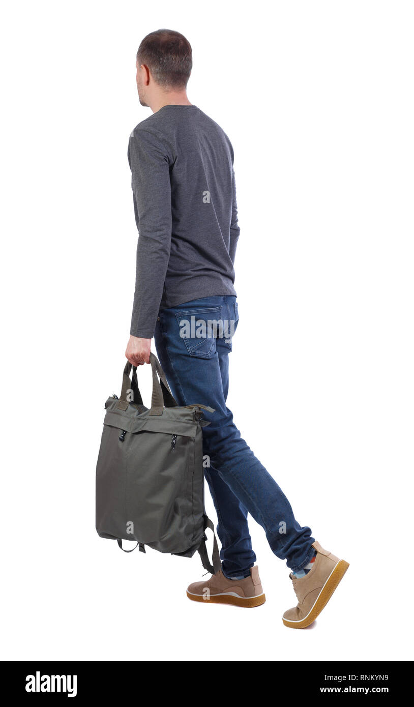 Side view of walking man with green bag. backside view of person. Rear ...