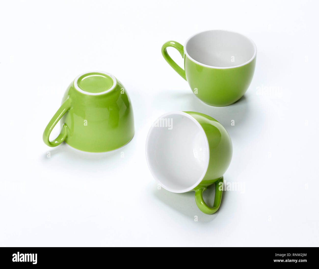 Three green espresso cups. Studio picture against a white background ...