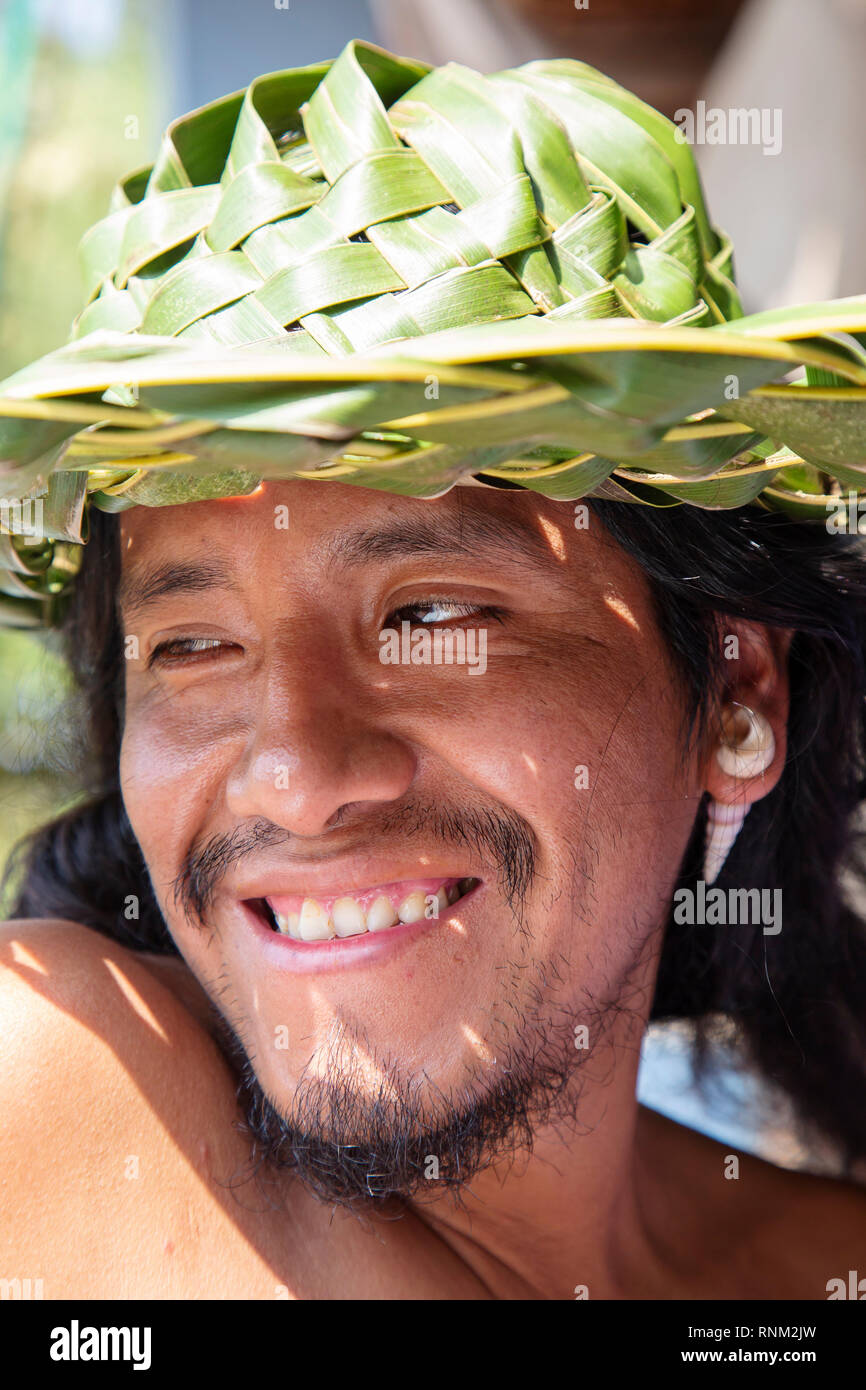 Portrait closeup of young native latino man with fresh handmade palm ...